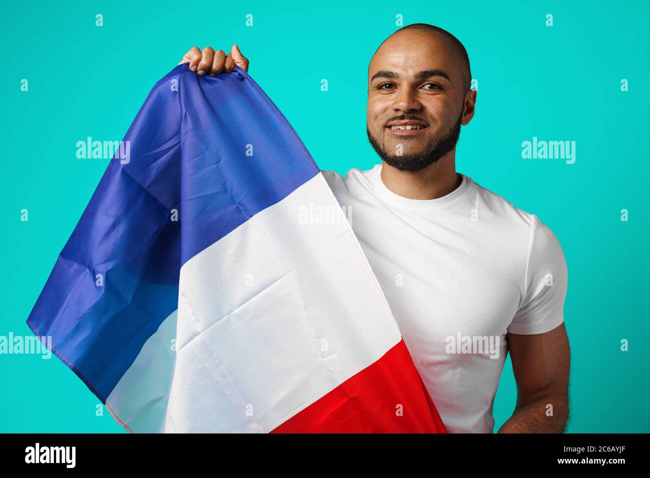 Mixed-race black man holding french flag close up Stock Photo - Alamy