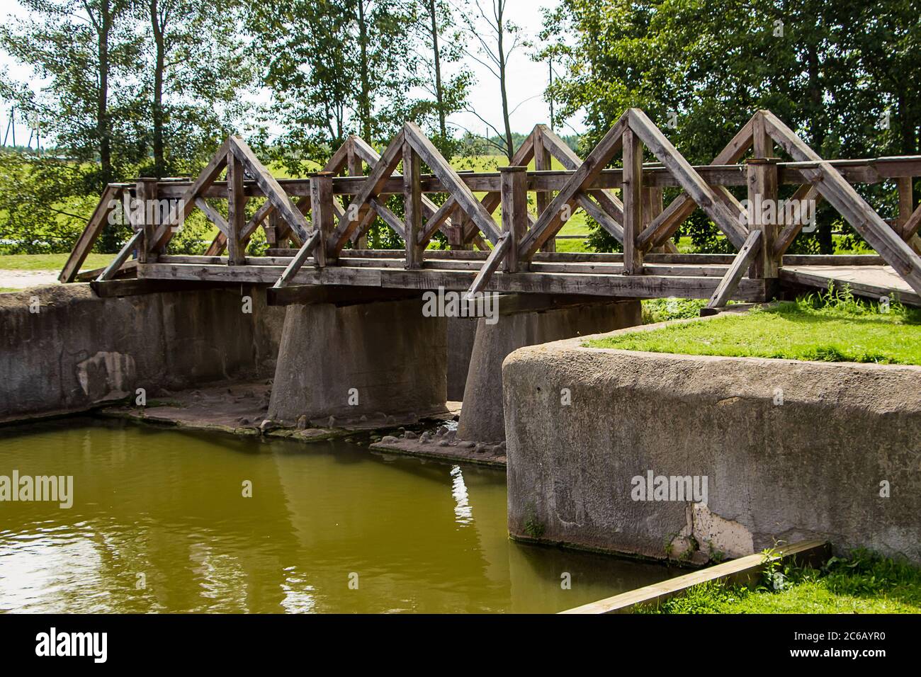 Old dam with a wooden bridge. View of the summer sunny landscape Stock ...