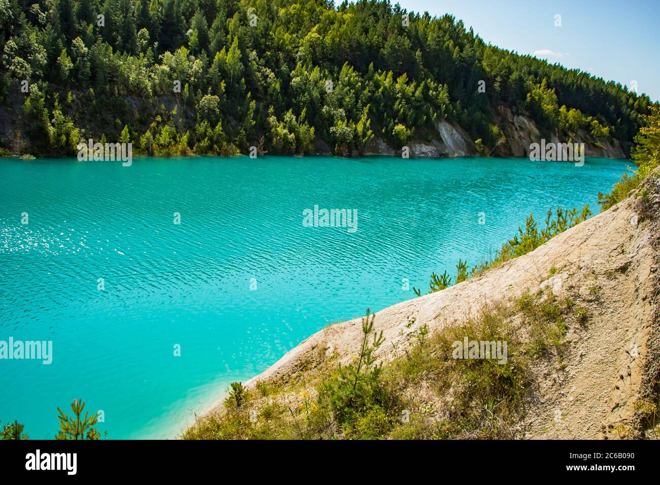 Unusual lake with turquoise water in the crater. Rocky stony shore ...