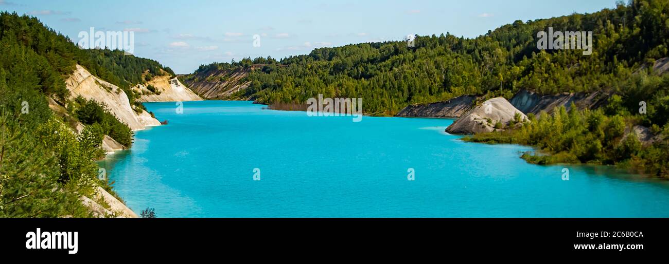 Unusual lake with turquoise water in the crater. Rocky stony shore ...