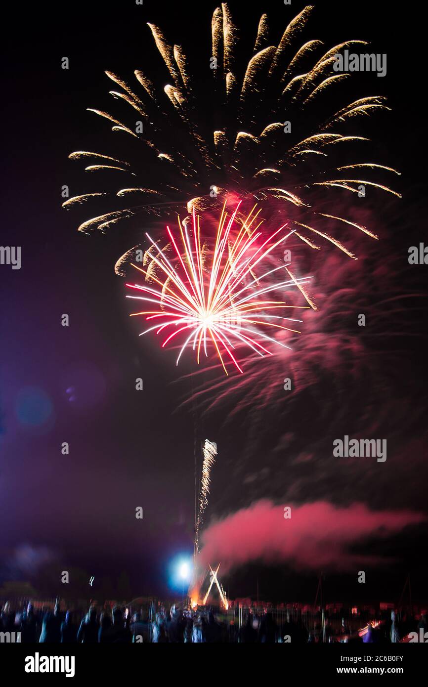 Beautiful colorful fireworks in the sky on a festive night. Vertical ...