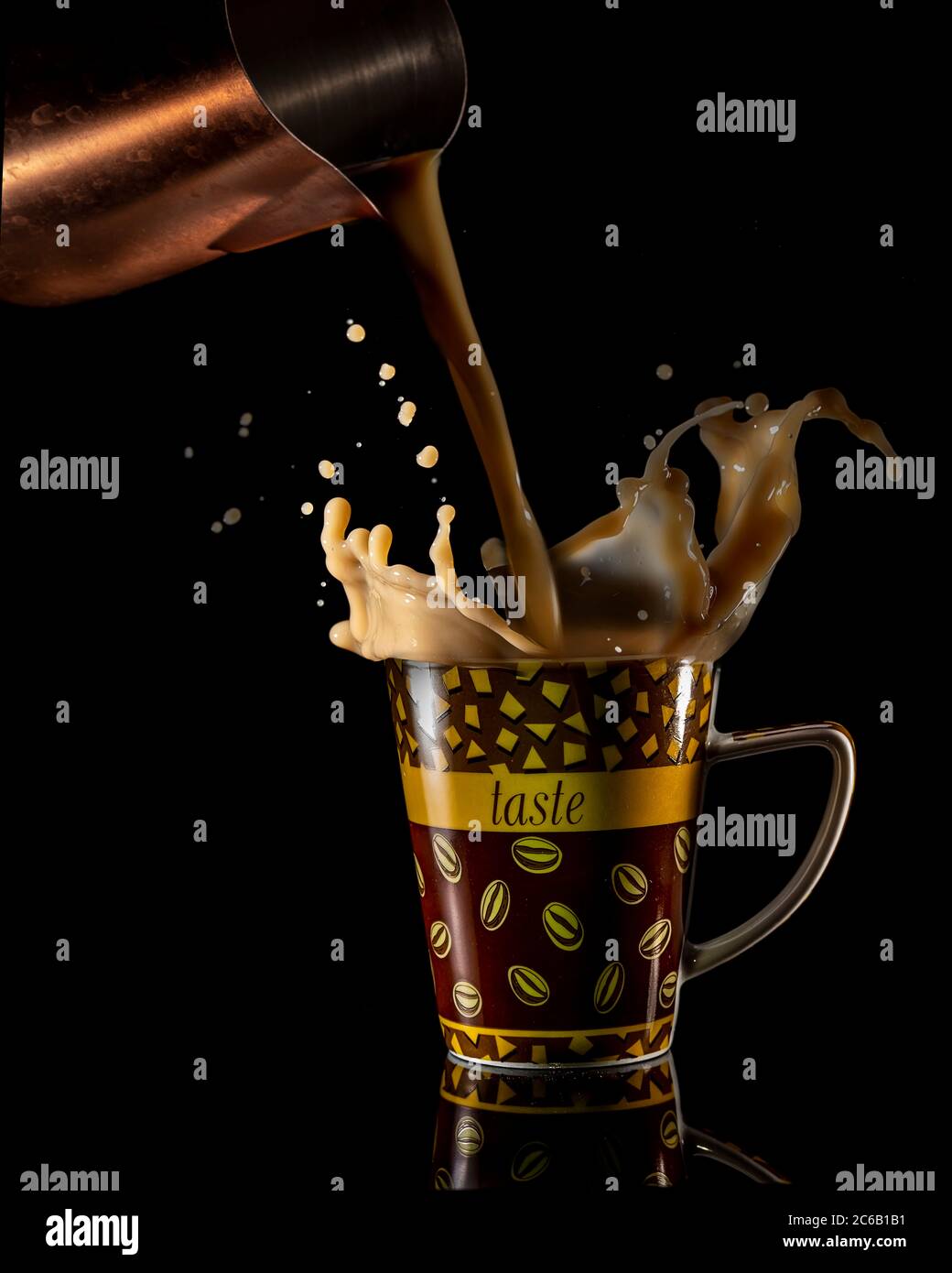 High speed flash photography with coffee splashing into mug Stock Photo ...