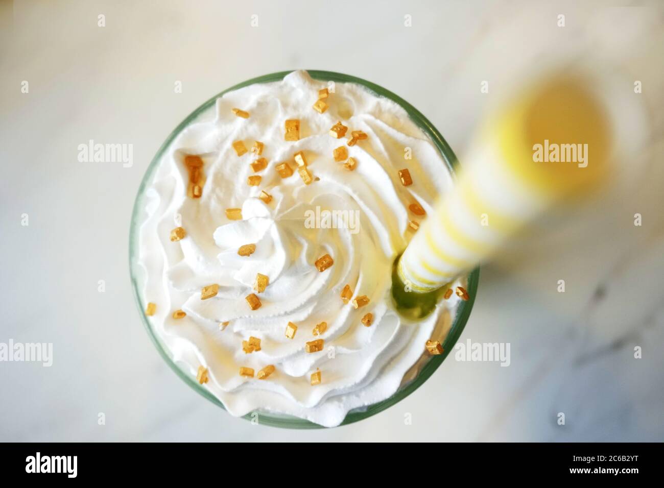 smoothie with cream with yellow straw Stock Photo - Alamy