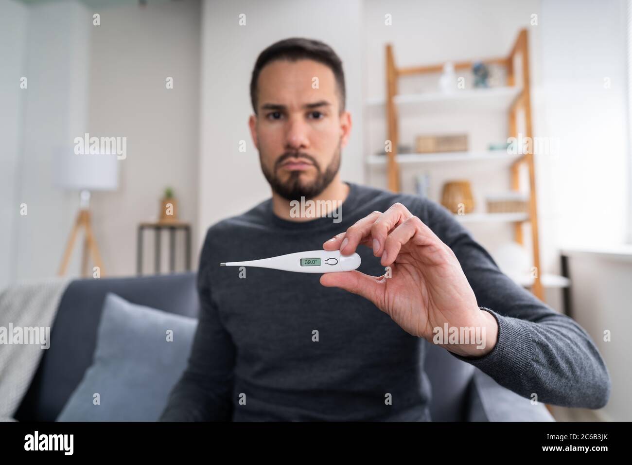Hand holding thermometer showing high hi-res stock photography and ...