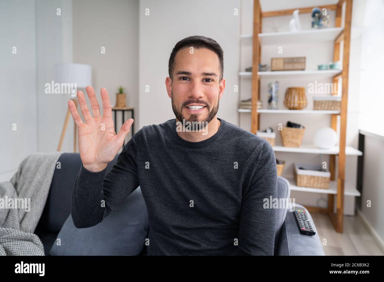 Happy Man On Couch Or Sofa In Living Room Stock Photo - Alamy