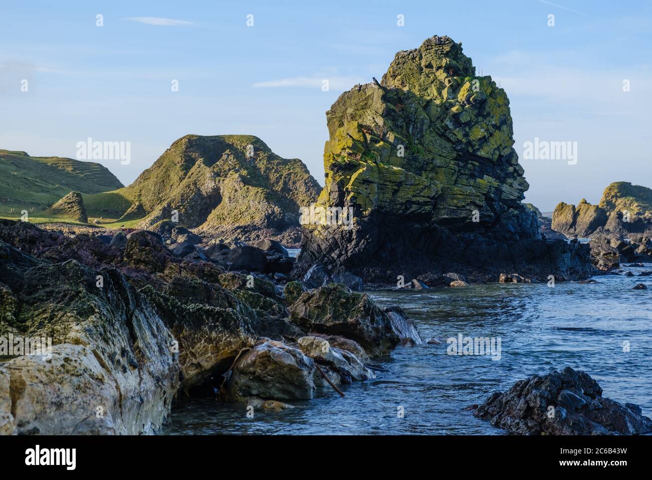 Colourful yellow and green rocks dominate the landscape at the small ...