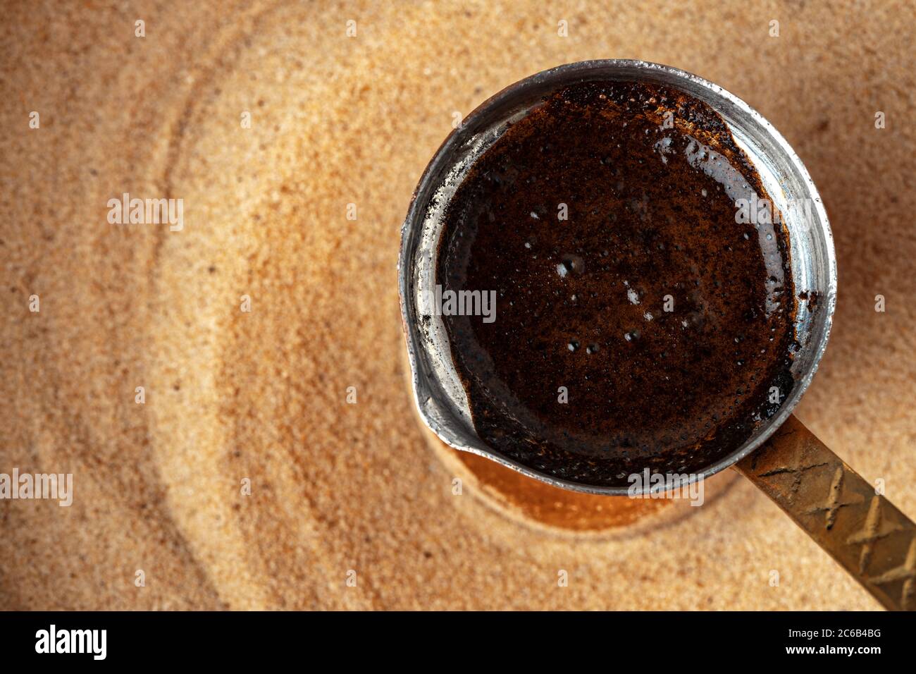 Turkish coffee in cezve on the sand Stock Photo - Alamy