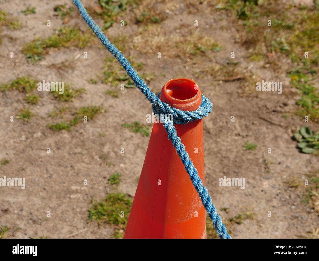 Bollard , orange traffic cone with blue rope used for social distancing ...