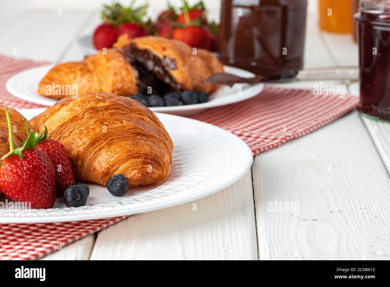 Fresh croissant decorated with berries on white wooden board Stock ...