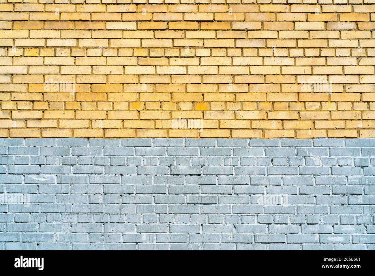 Wall of yellow and gray bricks. Abstract architectural background Stock ...