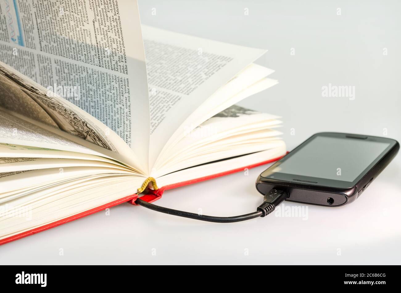 Smartphone connected via USB to a book Stock Photo - Alamy