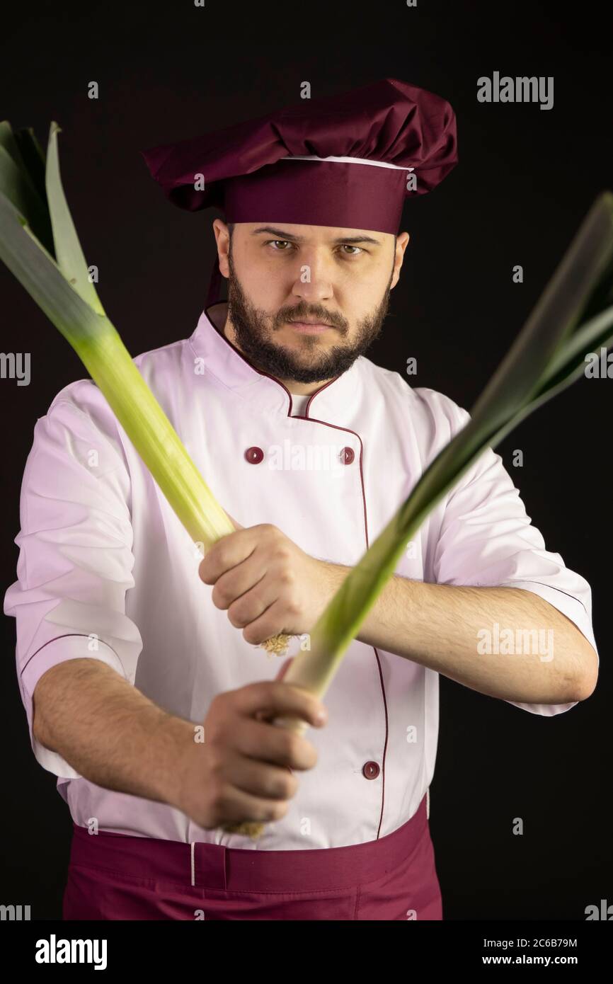bearded chef cook in uniform holding lettuce onions in hands like ...