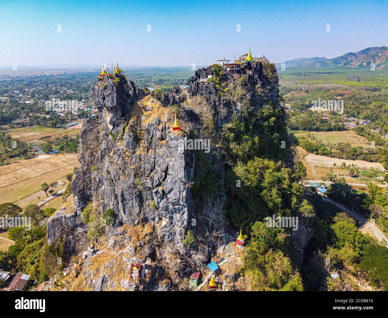 Aerial by drone of Kyauktalon Taung crag with a Hindu temple, near ...