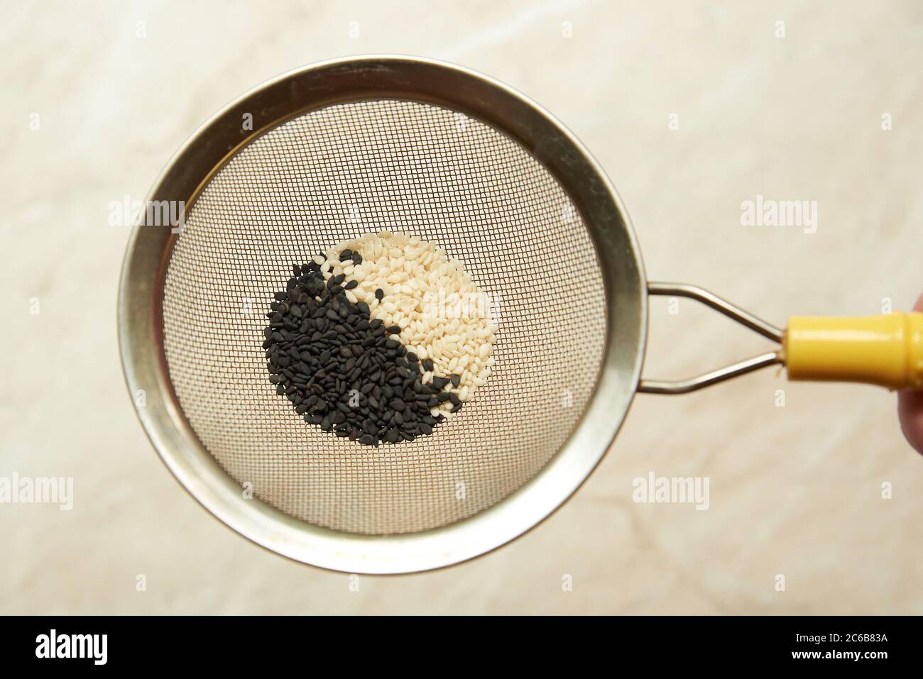 White and black sesame in the sieve Stock Photo - Alamy