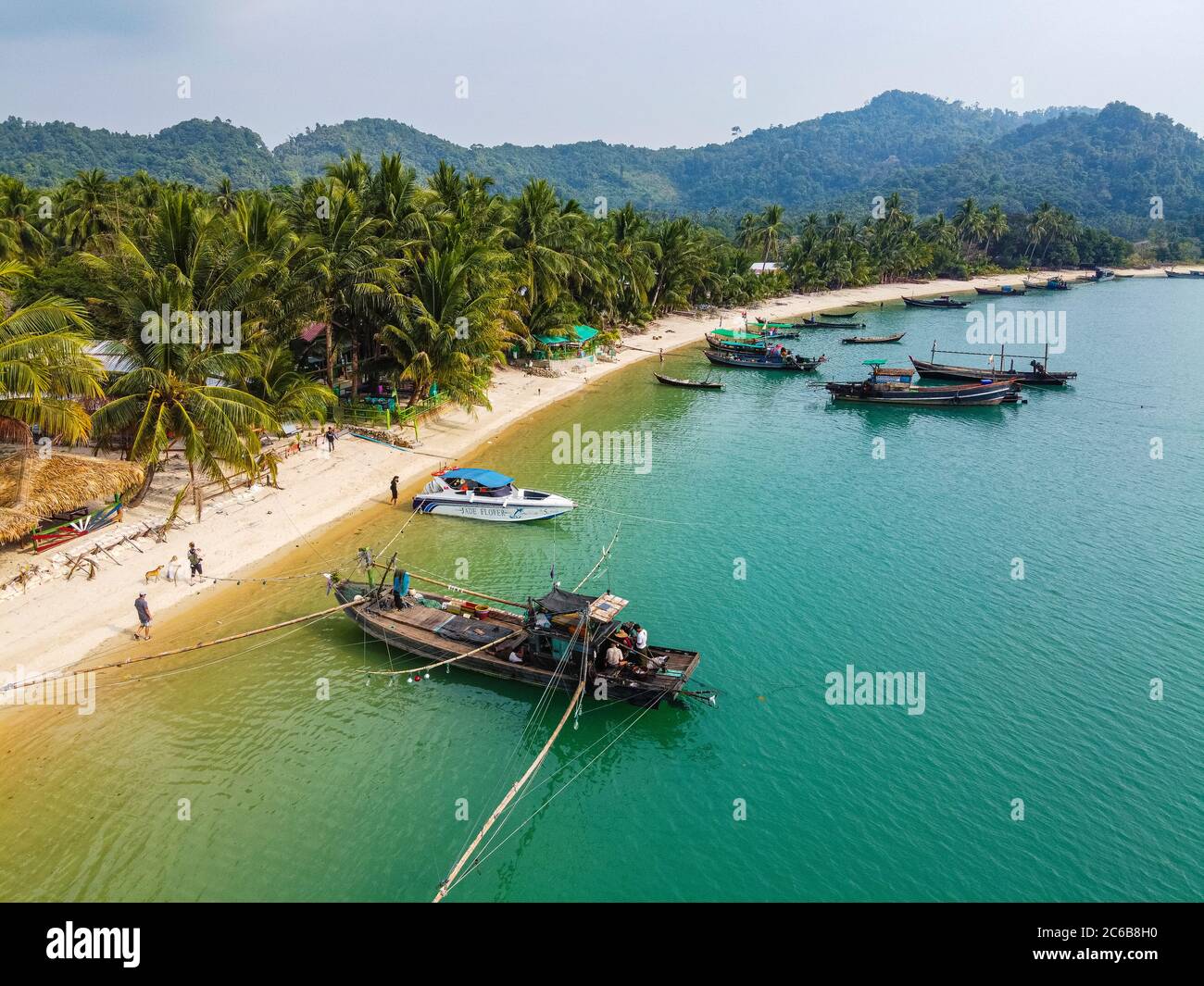 Aerial by drone of a Moken, sea gypsy village on a white sand beach ...
