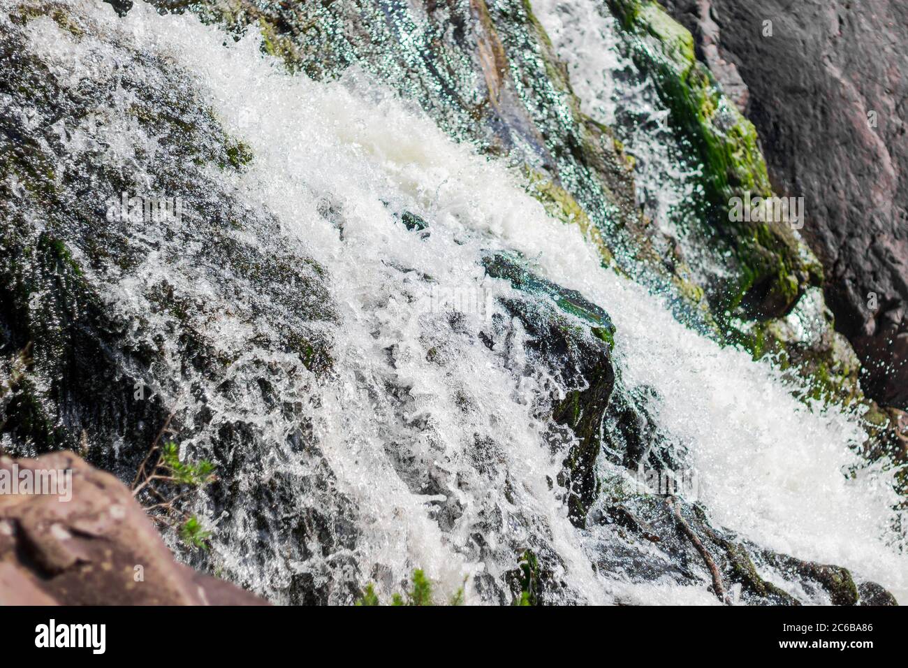 Beautiful mountain waterfall, powerful streams of water among the ...