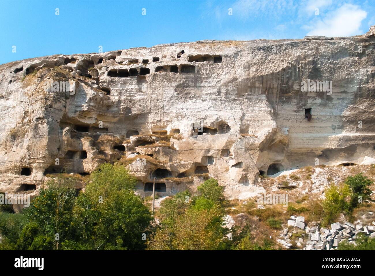 Ancient caves carved into the mountain wall hi-res stock photography ...
