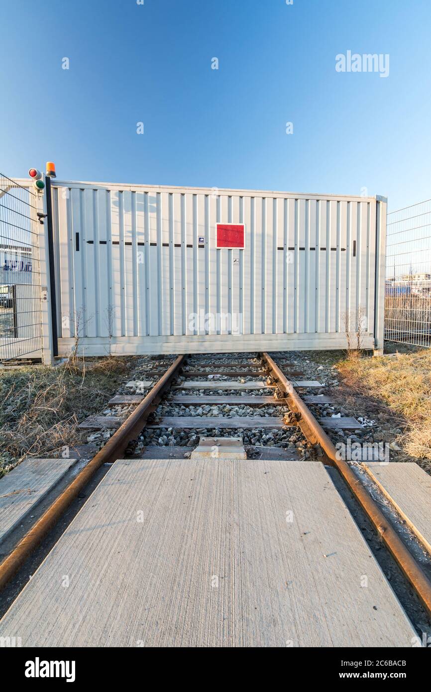 Rail tracks leading to an industrial gate Stock Photo - Alamy