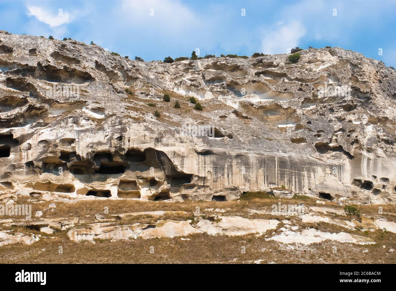 Ancient caves carved into the mountain wall hi-res stock photography ...