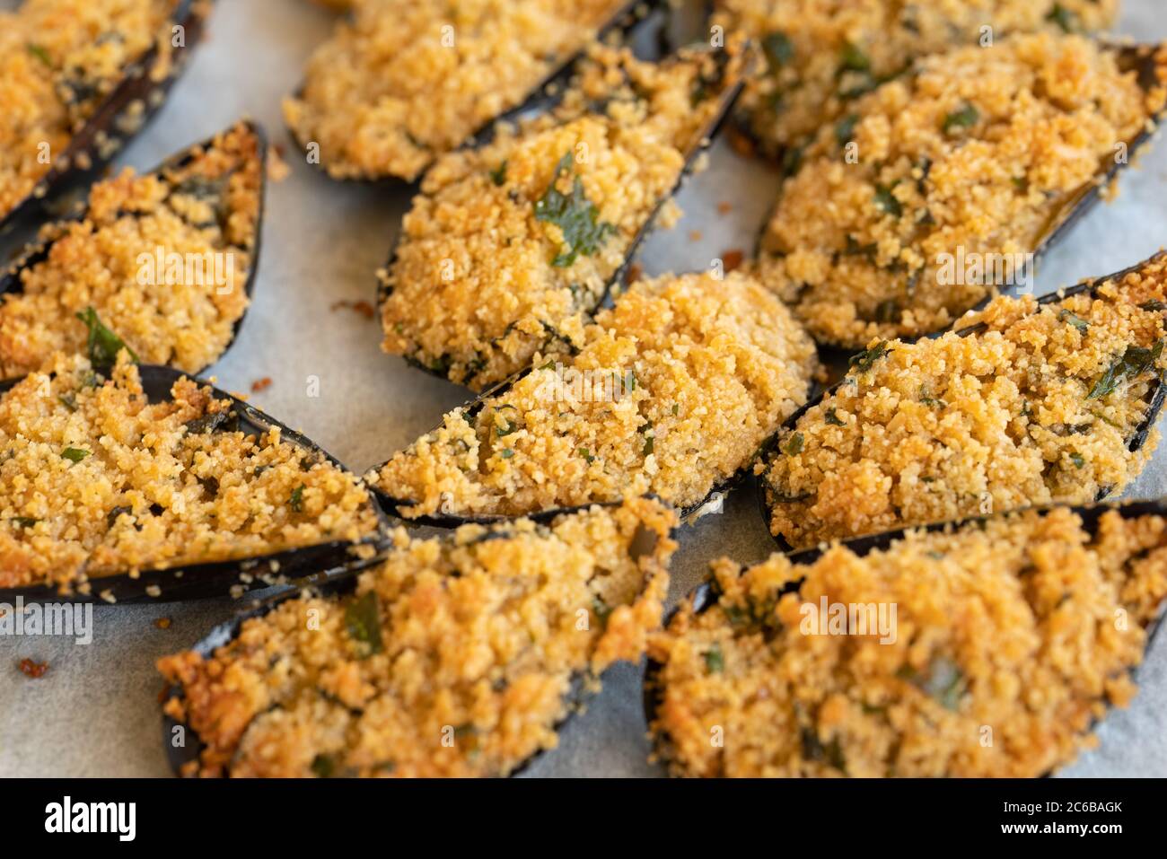 Mussels au Gratin Baked isolated on white background Stock Photo - Alamy