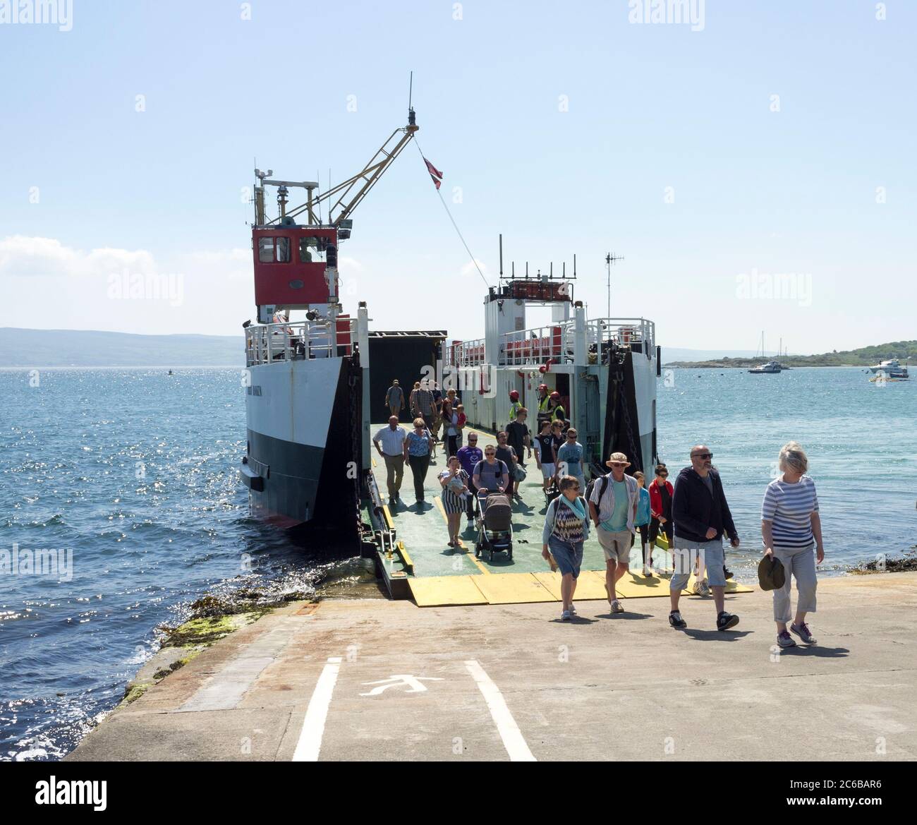 Passengers arriving on The MV Loch Ranza Ferry at the Island of Gigha ...