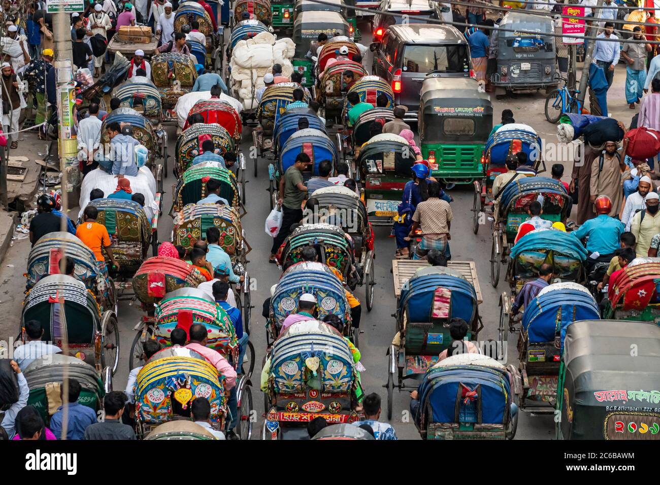 Overcrowded completely with rickshaws, a street in the center of Dhaka ...