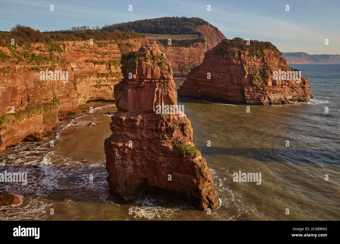 Red sandstone cliffs and rocks at Ladram Bay, in the Jurassic Coast ...