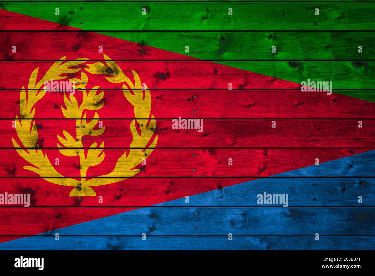 The national flag of Eritrea is painted on a camp of even boards nailed ...