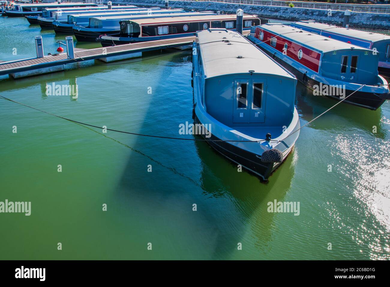 river boats parked at a dock in parque das nacoes in the oriental part of Lisbon in Portugal ...