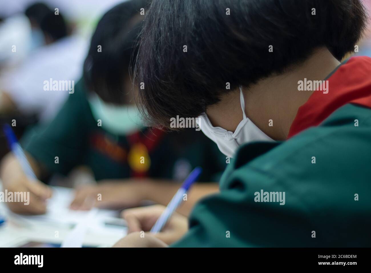 Asian uniform students wears a mask, intending to study in the ...