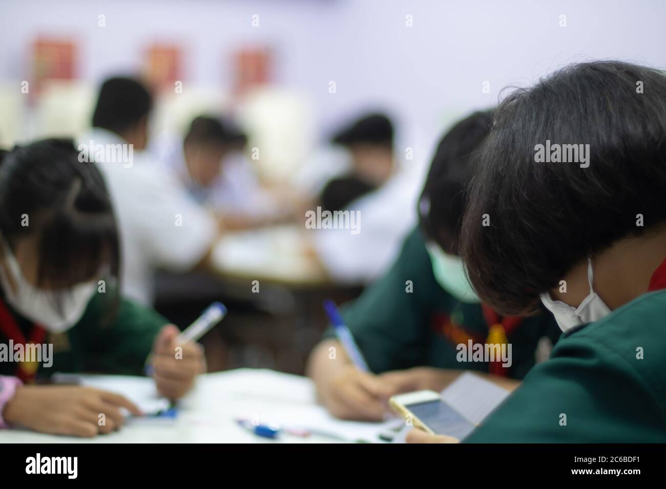 Asian uniform students wears a mask, intending to study in the ...