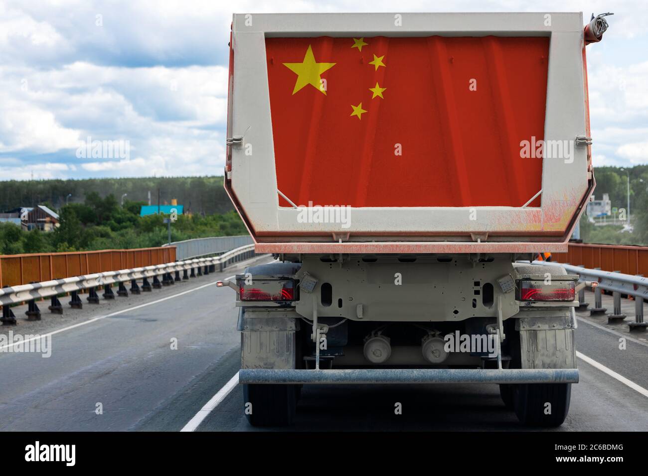 Big truck with the national flag of China moving on the highway ...