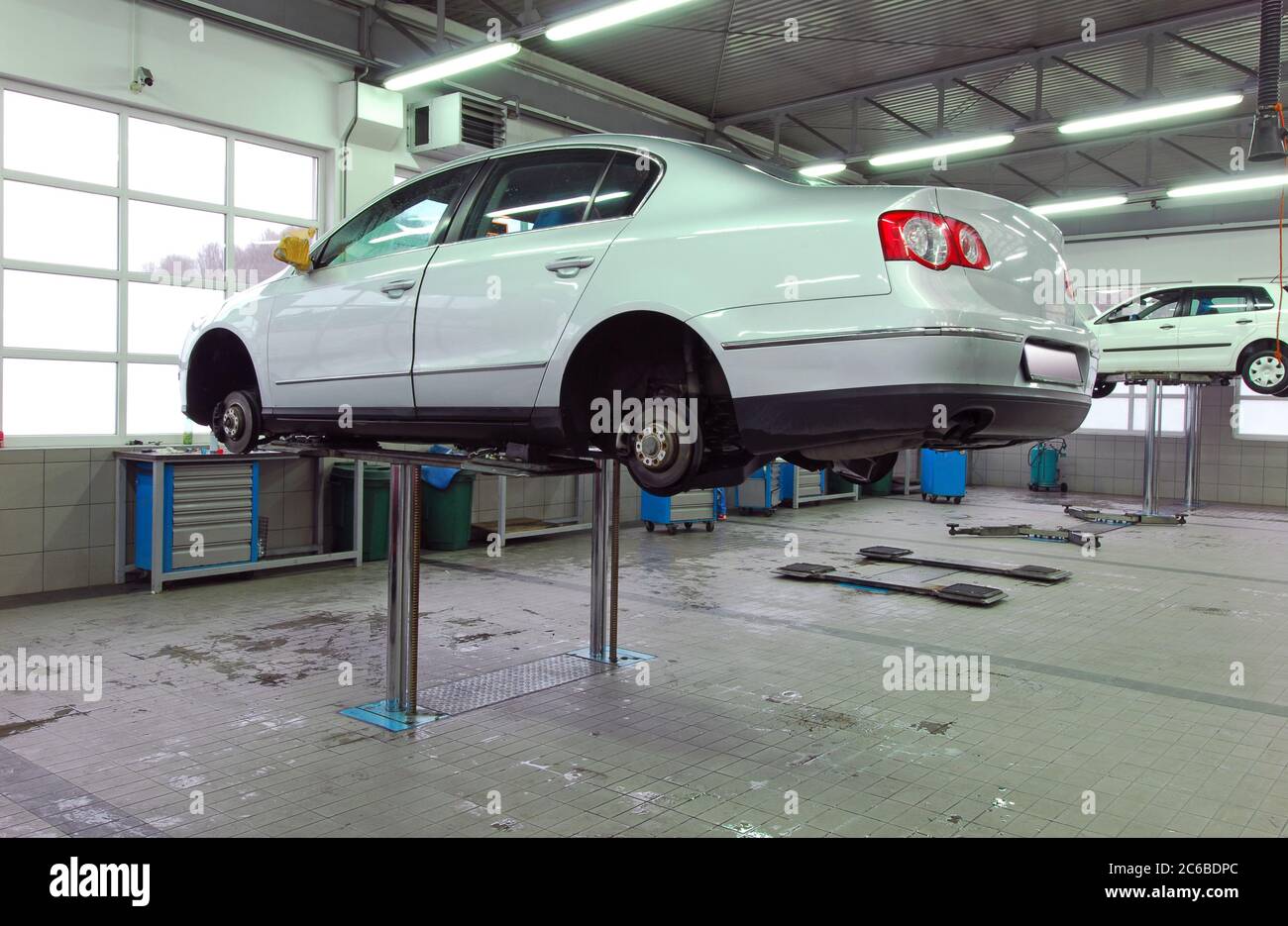 Cars in the automotive service, Car on base plate of lift in workshop ...