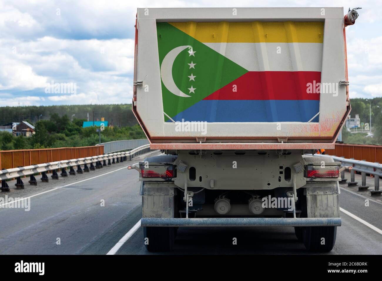Big truck with the national flag of Comoros moving on the highway ...