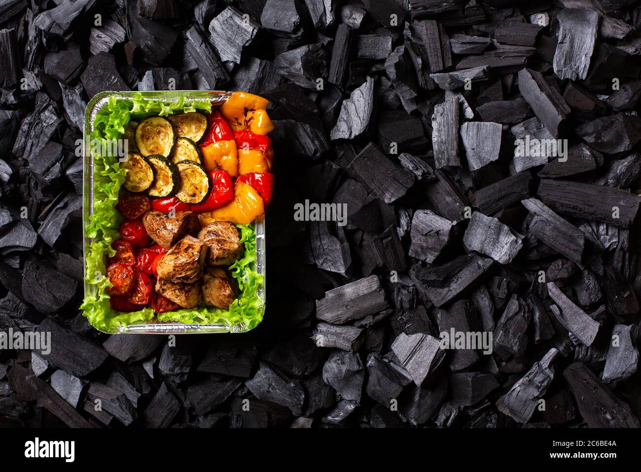 Ready shish kebab. Portion of grilled meat and vegetables in a ...