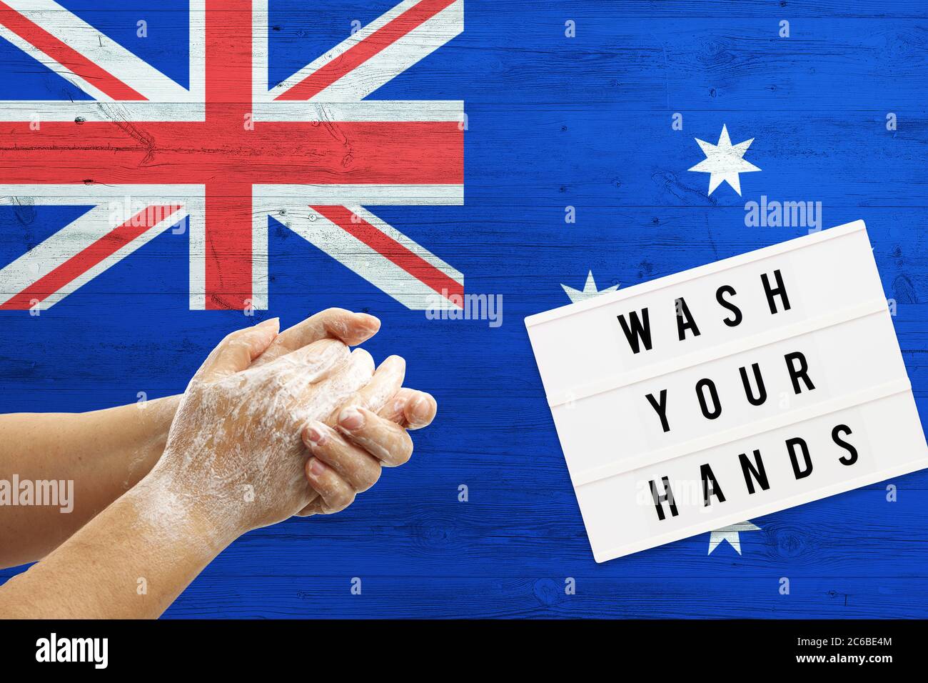 Australia flag background on wooden surface. Minimal wash your hands ...