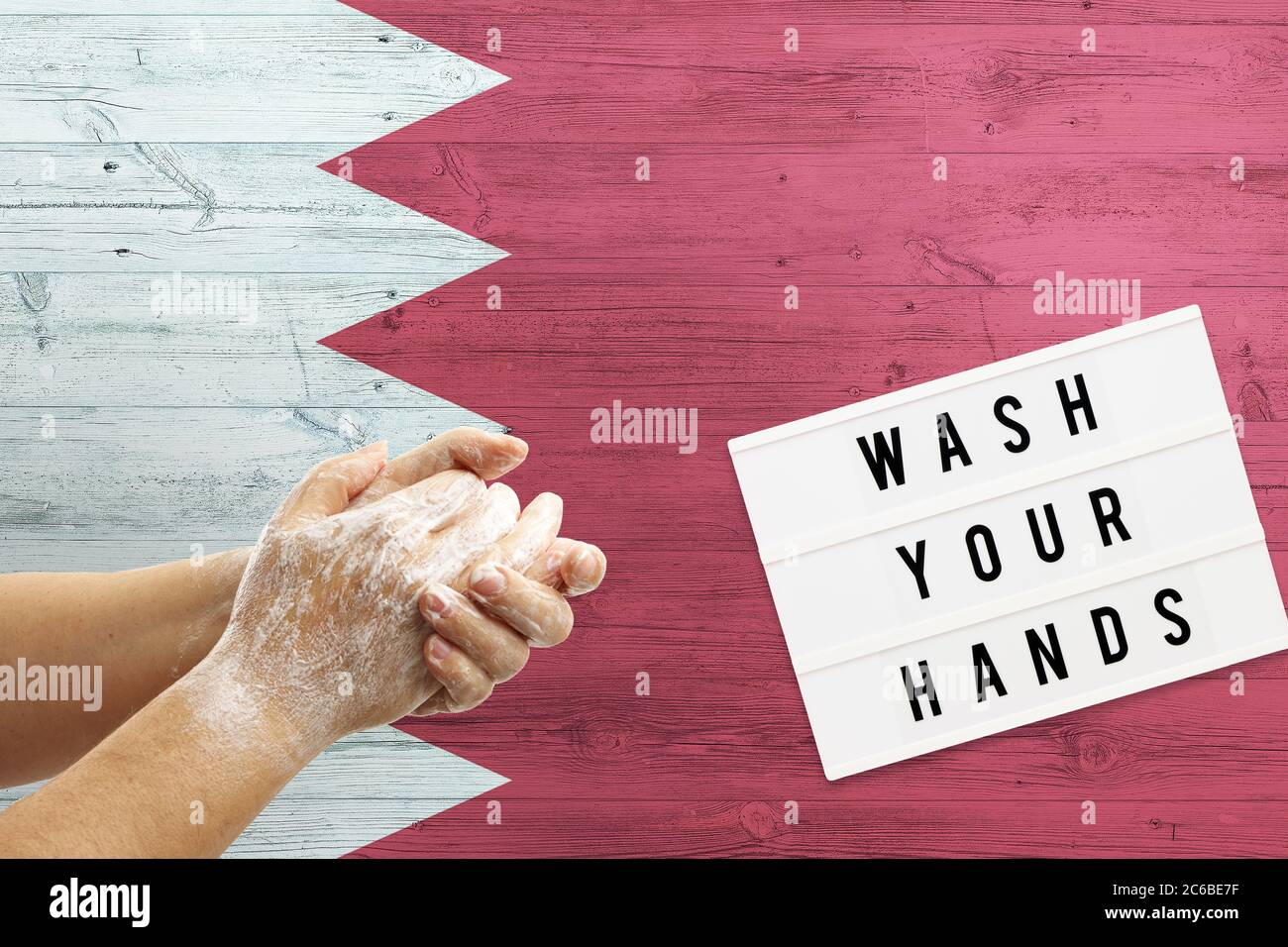 Bahrain flag background on wooden surface. Minimal wash your hands ...