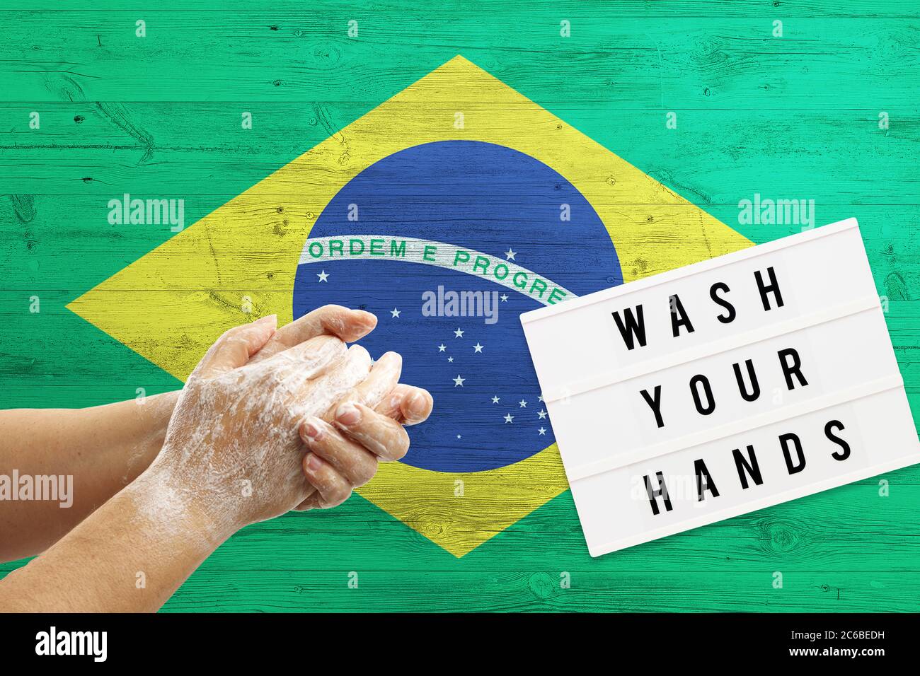 Brazil flag background on wooden surface. Minimal wash your hands board ...