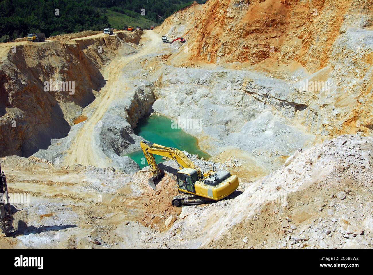 Yellow loader, dredge, big yellow loader carries a large stone in the ...