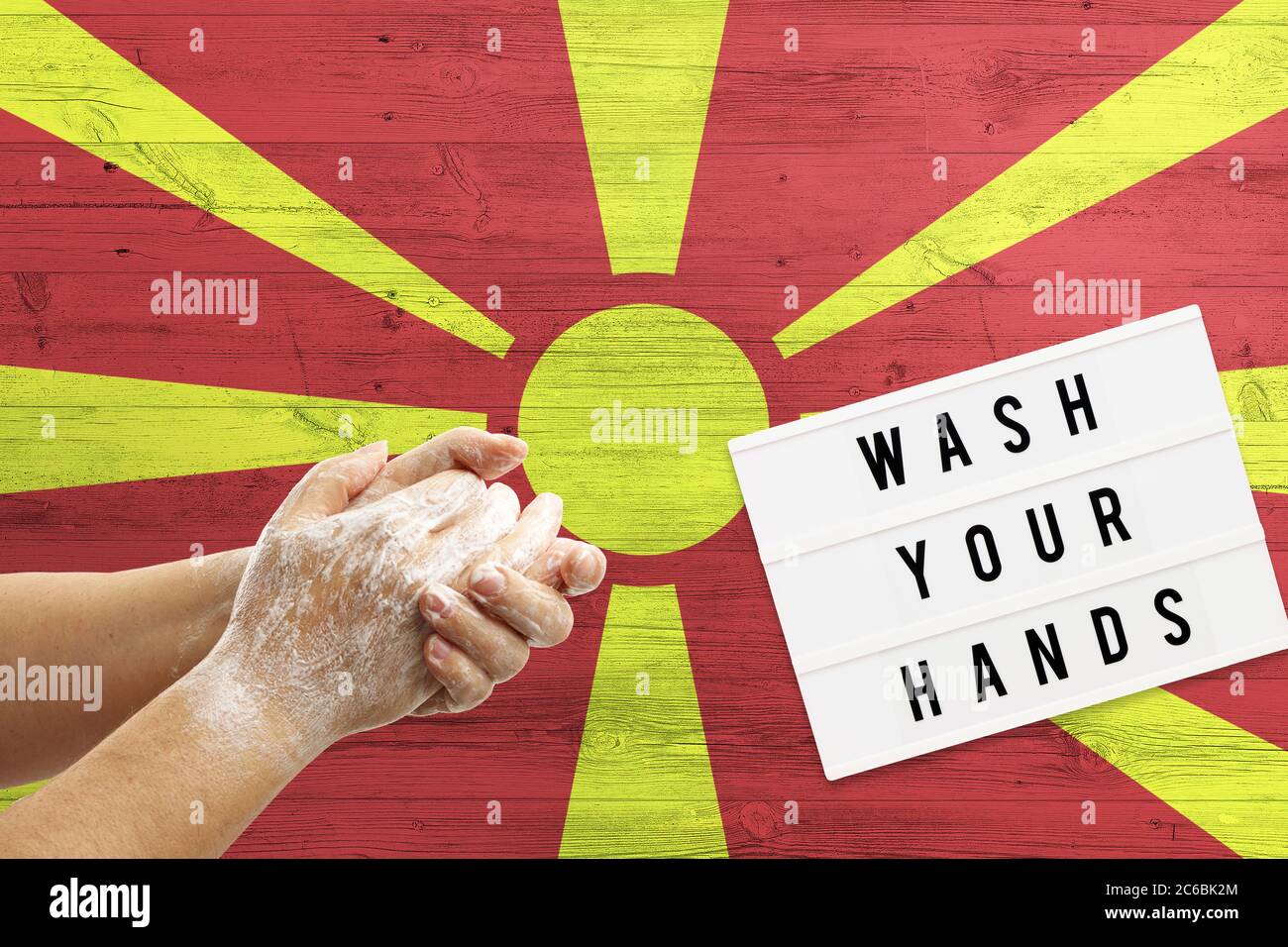 Macedonia flag background on wooden surface. Minimal wash your hands ...