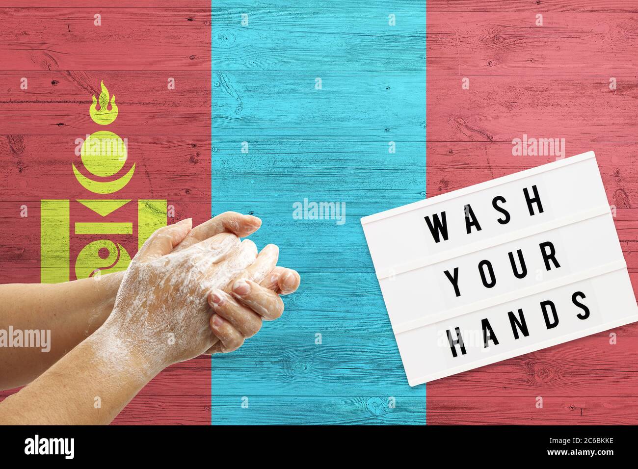 Mongolia flag background on wooden surface. Minimal wash your hands ...