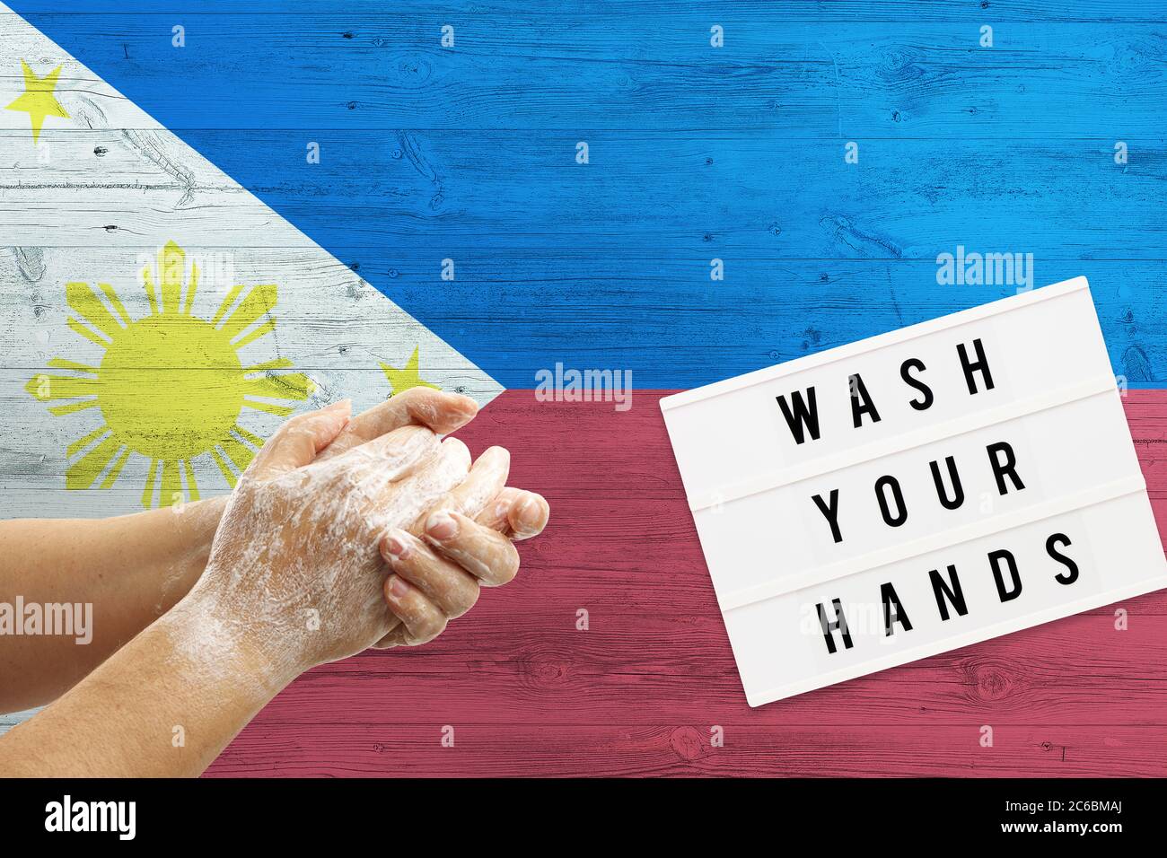 Philippines flag background on wooden surface. Minimal wash your hands ...