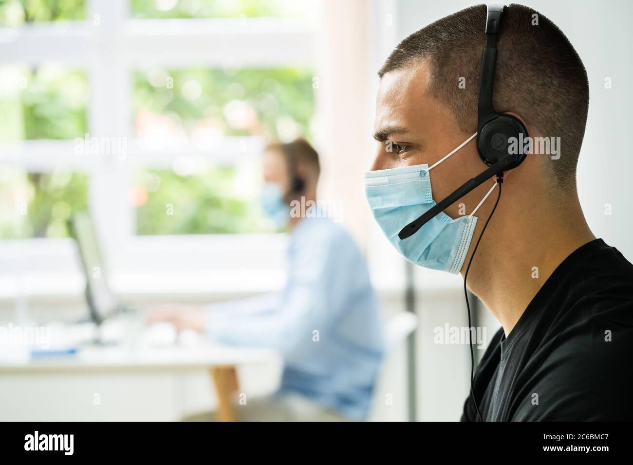 Call Center Telephone Operator In Office Wearing Face Mask Stock Photo ...