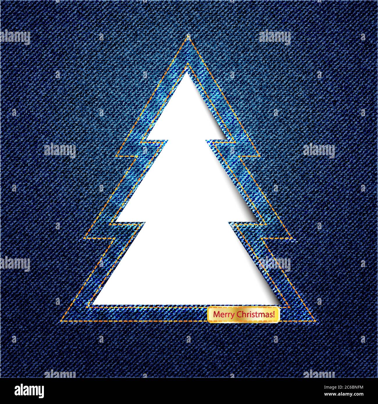 A Christmas tree cutout on denim background with space for text. Also ...