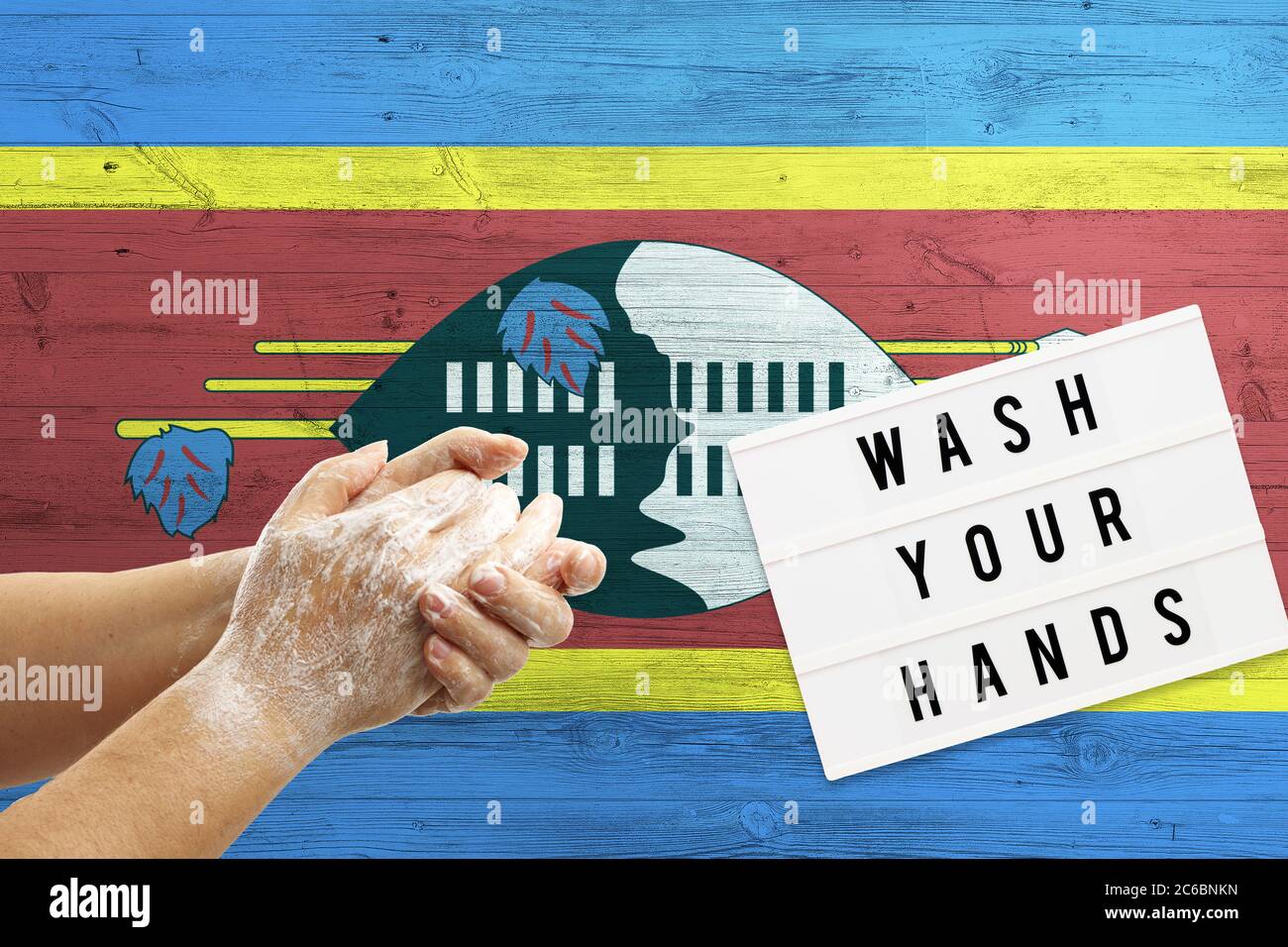 Swaziland flag background on wooden surface. Minimal wash your hands ...