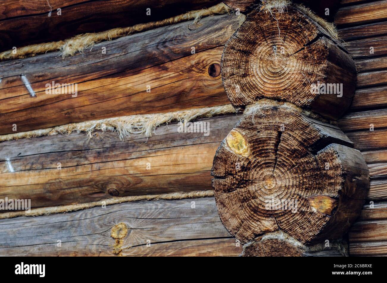 Wooden background. Logs on the wall of the log frame as a background ...