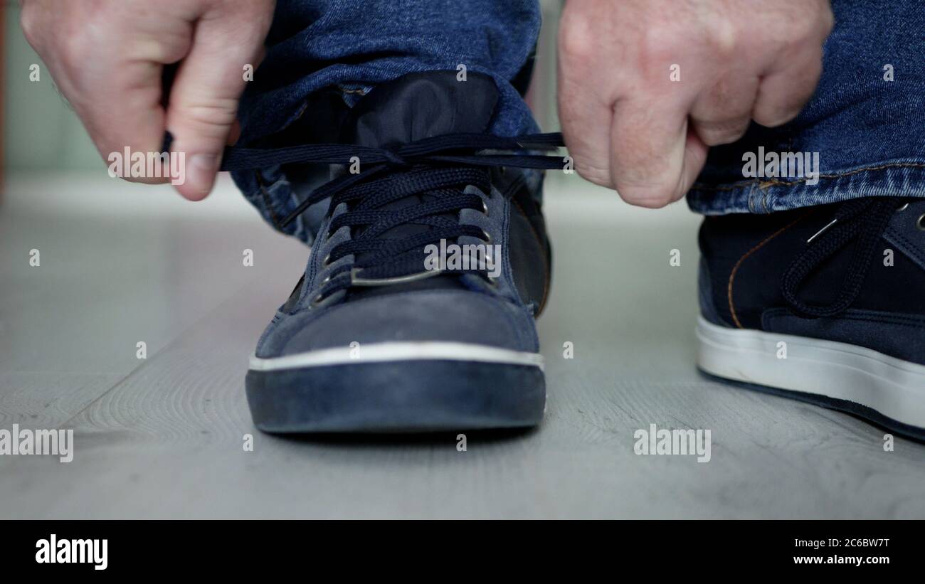 Person hands tying shoes hi-res stock photography and images - Alamy