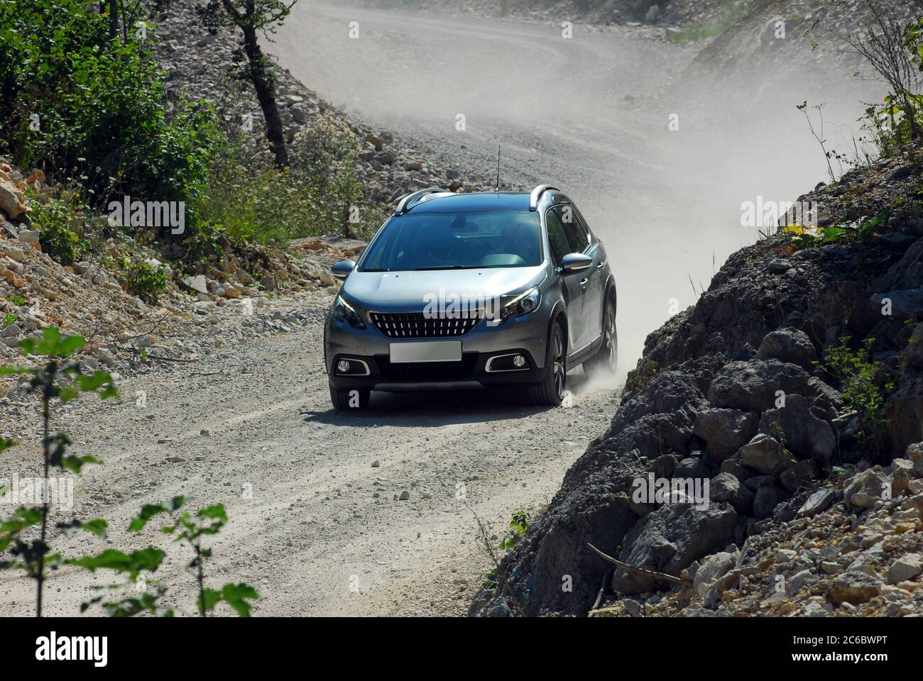 4WD vehicle driving on a narrow dirt road. SUV driving on a narrow dirt ...