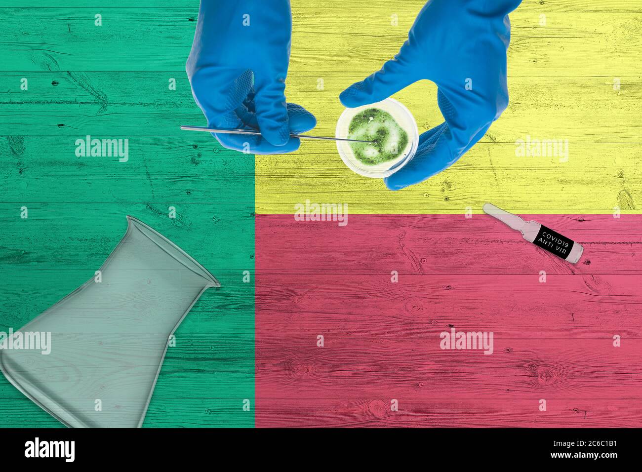 Benin flag on laboratory table. Medical healthcare technologist holding ...