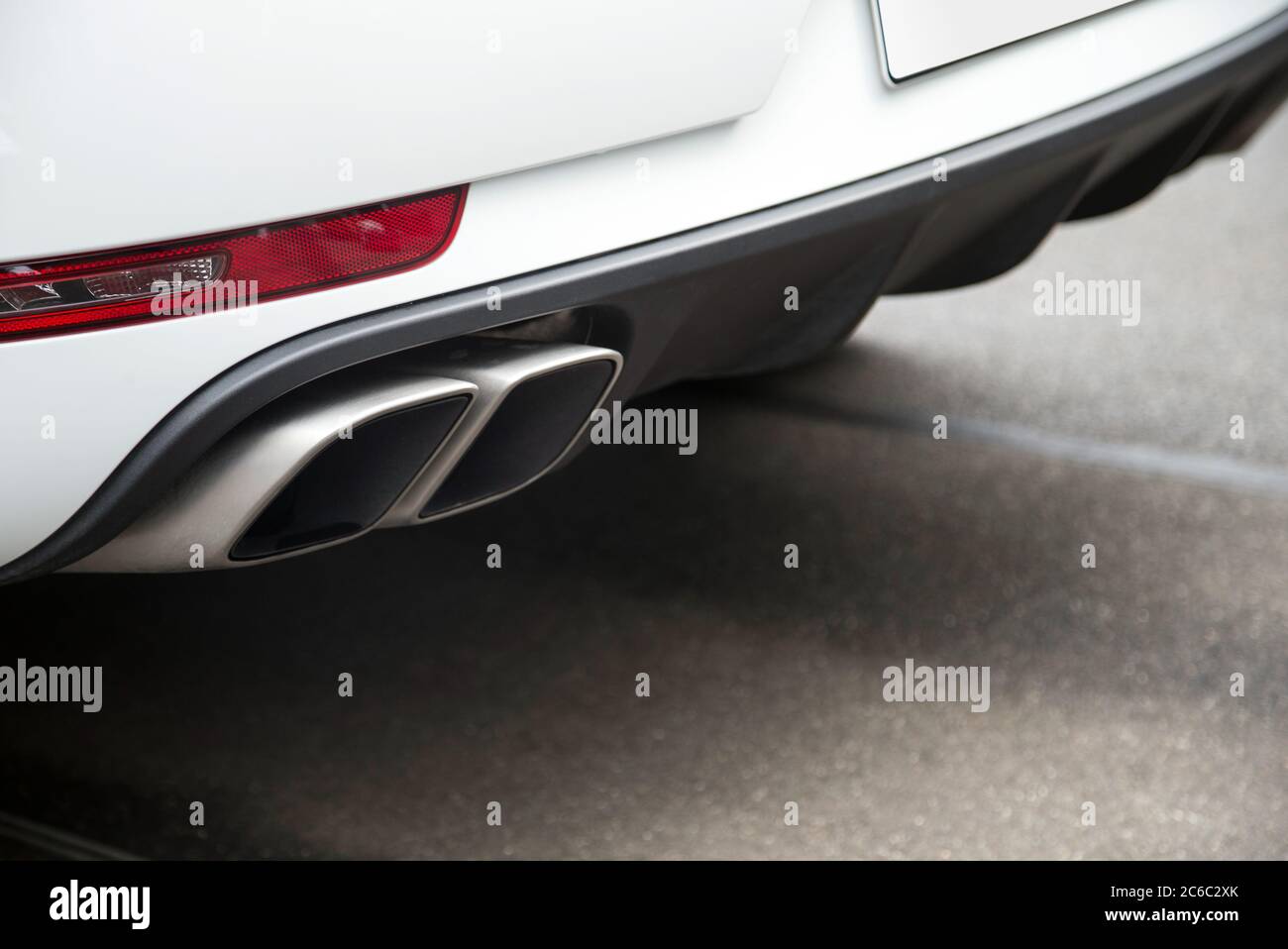 Exhaust pipe system. Tailpipe sports car. Close up of tailpipe on white ...